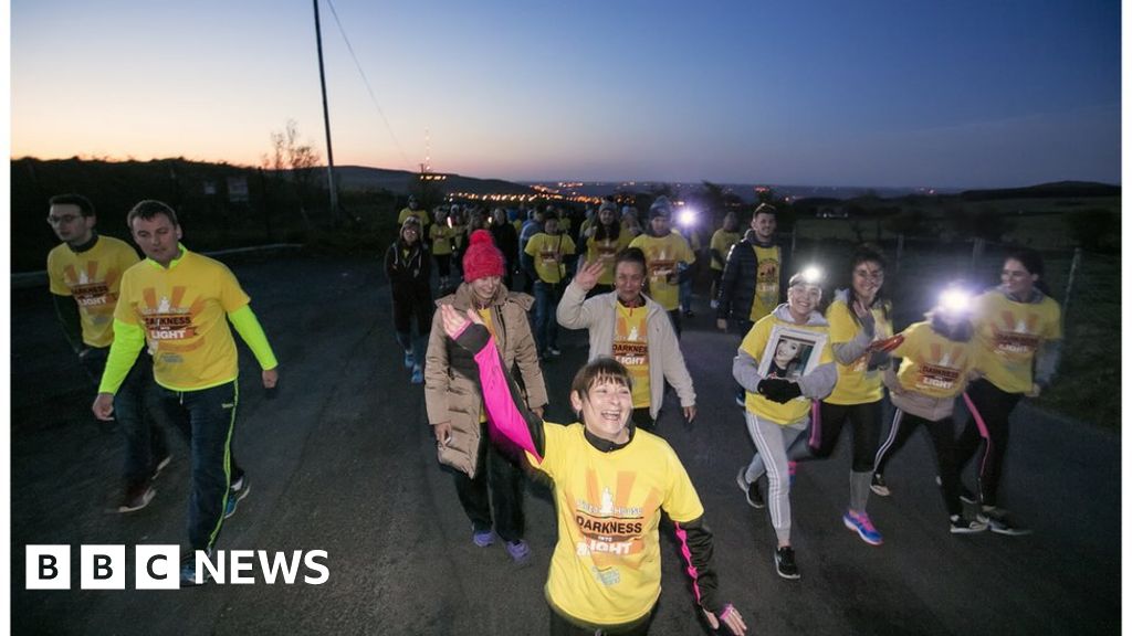 Thousands walk path from darkness into light - BBC News