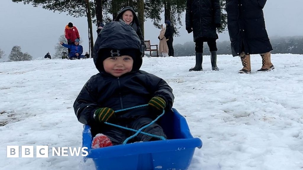 Children go sledging in Cofton Park after heavy snow - BBC News