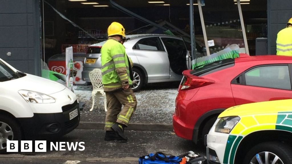 Car crashes into shop window in Belfast - BBC News