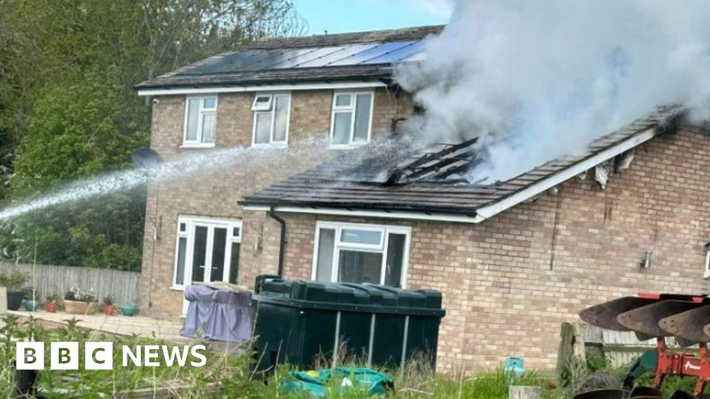 Mollington house fire: Flames engulf roof after electrical fault - BBC News