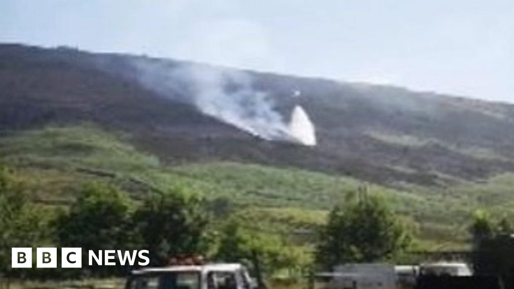 Helicopter drops water on Maerdy mountain fire