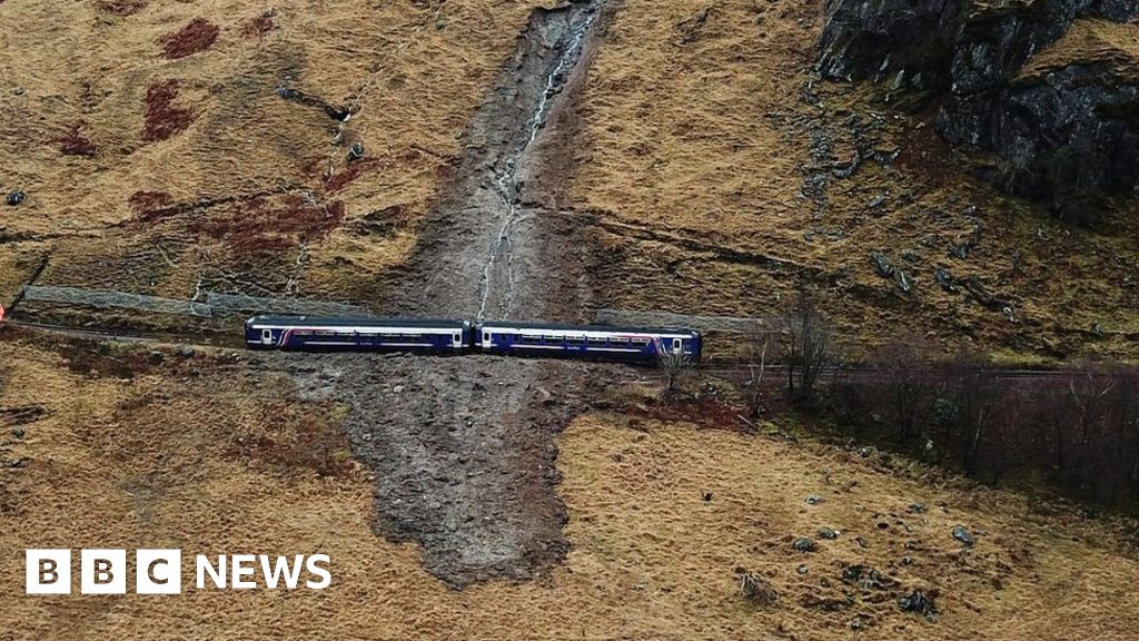 Drone image of train stuck in landslip in Highlands - BBC News