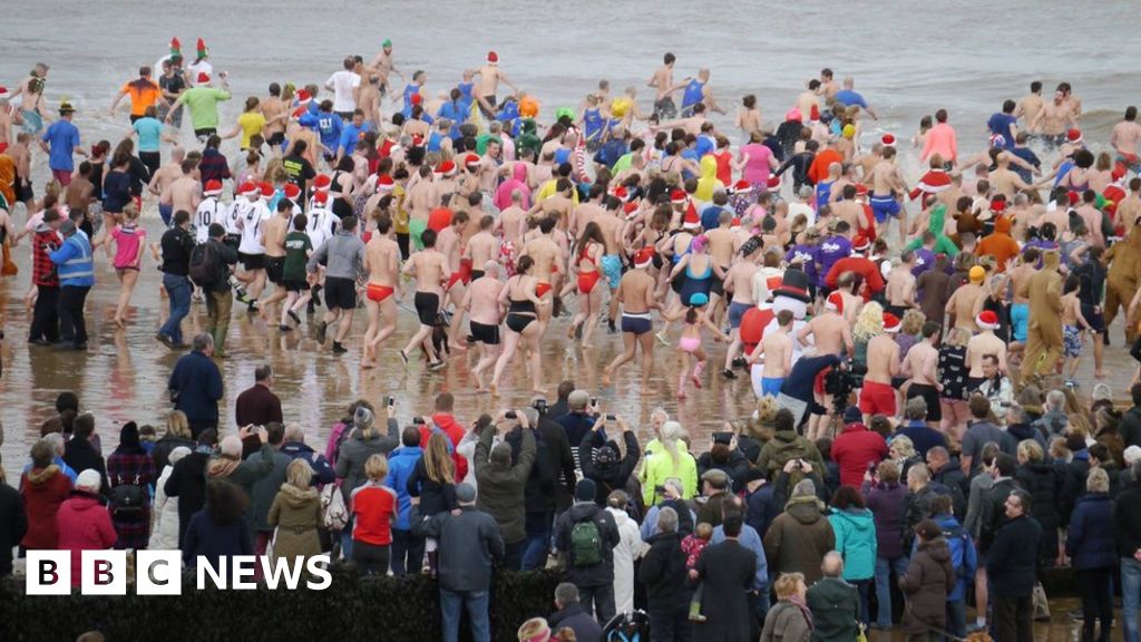 'Record turnout' at Cromer festive swim - BBC News