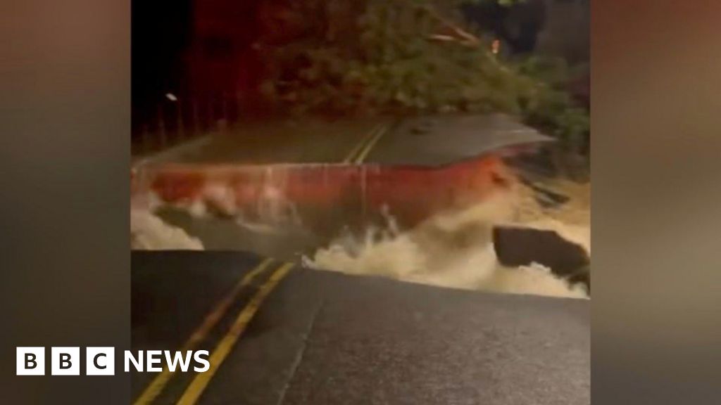 Watch: Moment road collapses from severe flash flooding - BBC News