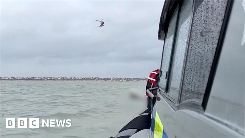 Men stuck on sand banks in the sea off Southend rescued - BBC News