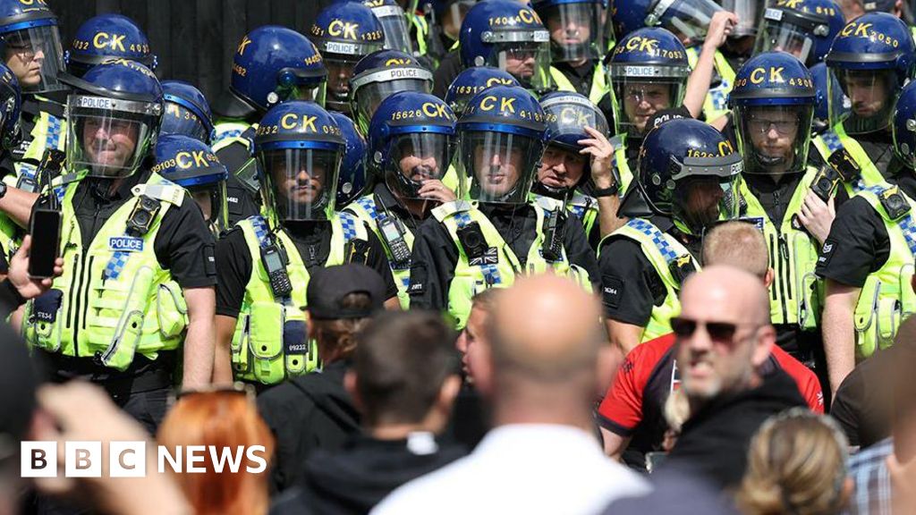 Man who threw bricks at police in asylum hotel riot jailed - BBC News