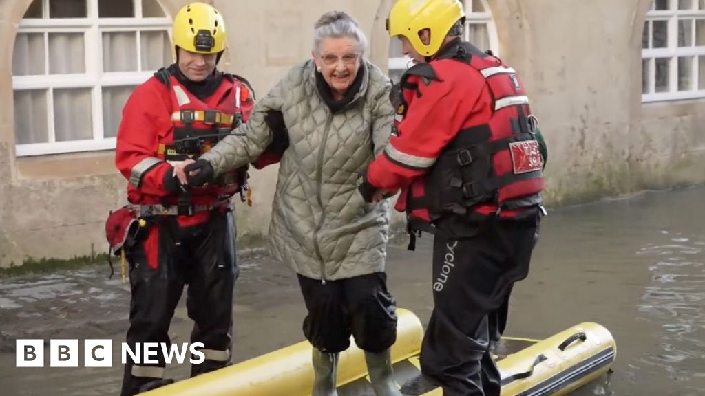 Emergency crews tackle flood waters in rescue operations - BBC News