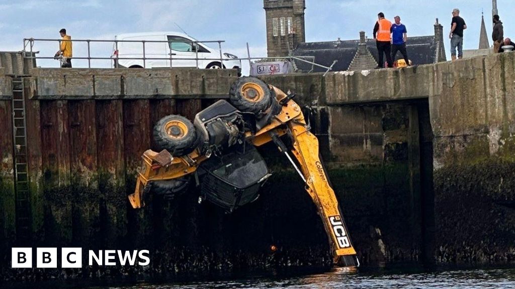 JCB crashes at Fraserburgh harbour after driver loses control - BBC News