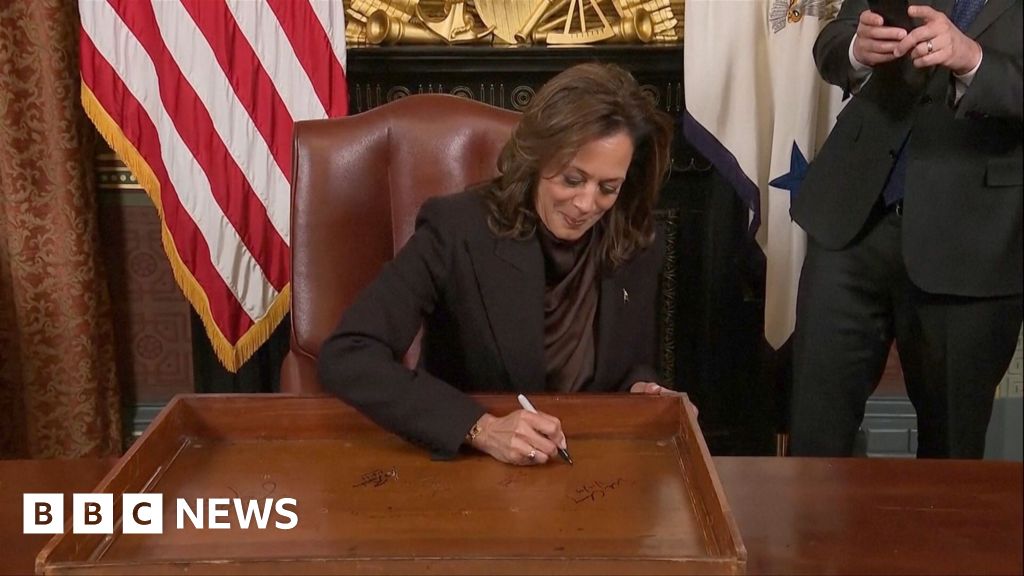 Moment Kamala Harris signs desk in vice-president office
