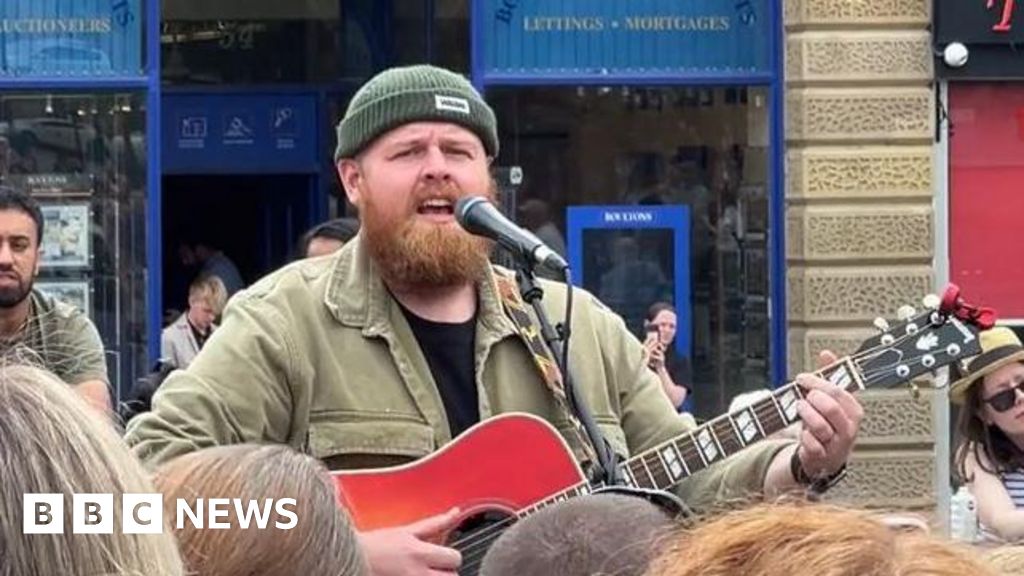 Brit Awards winner Tom Walker performs in Huddersfield town centre