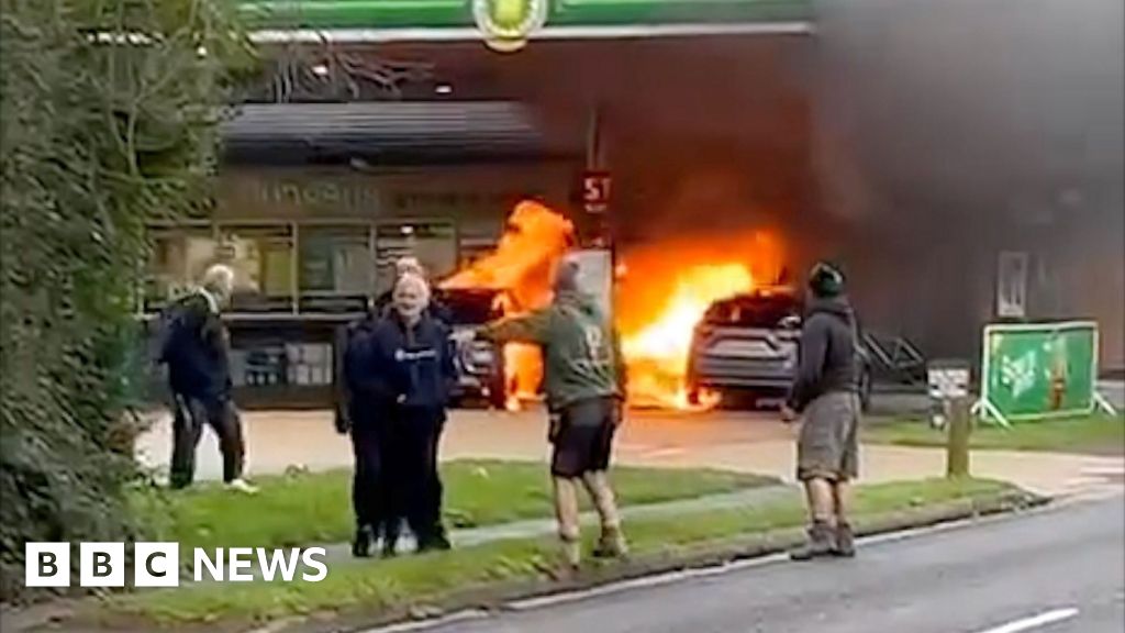 Watch: Fire engulfs petrol station as man arrested - BBC News