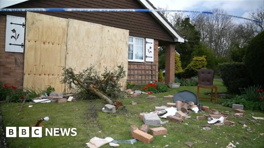 Two hurt when car hits house in Bedworth before being driven away