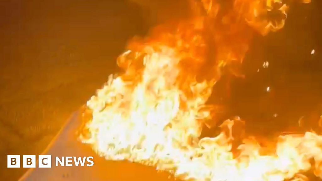 Video shows mattress and bushes engulfed in fire in Peterborough - BBC News