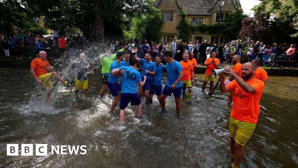 Annual Bourton-on-the-Water river football match takes place - BBC News