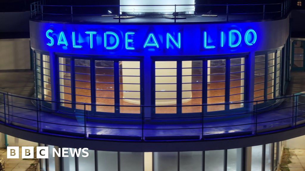 Saltdean Lido: Sign lit up for first time since World War Two - BBC News