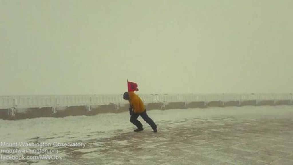 Man struggles to stand in 100mph winds - BBC Weather