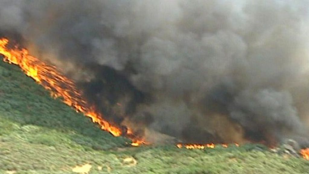Firefighters battle forest fires in Portugal - BBC Newsround