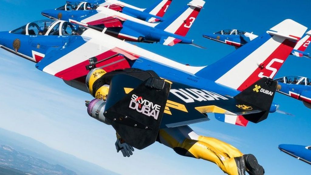 'Jetman' Yves Rossy flies alongside real jets - BBC Newsround