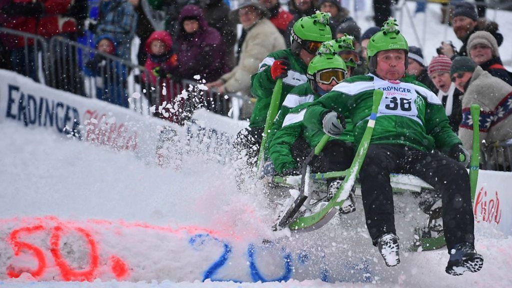 Sledgers slip and slide down icy track in annual competition - BBC ...