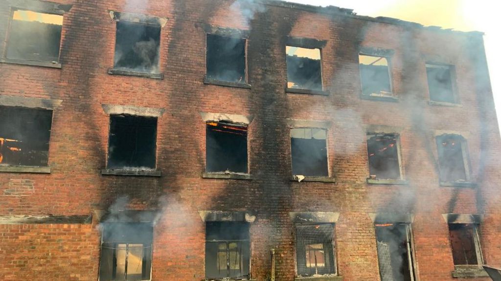 Fire crews work through night to extinguish derelict mill fire - BBC News