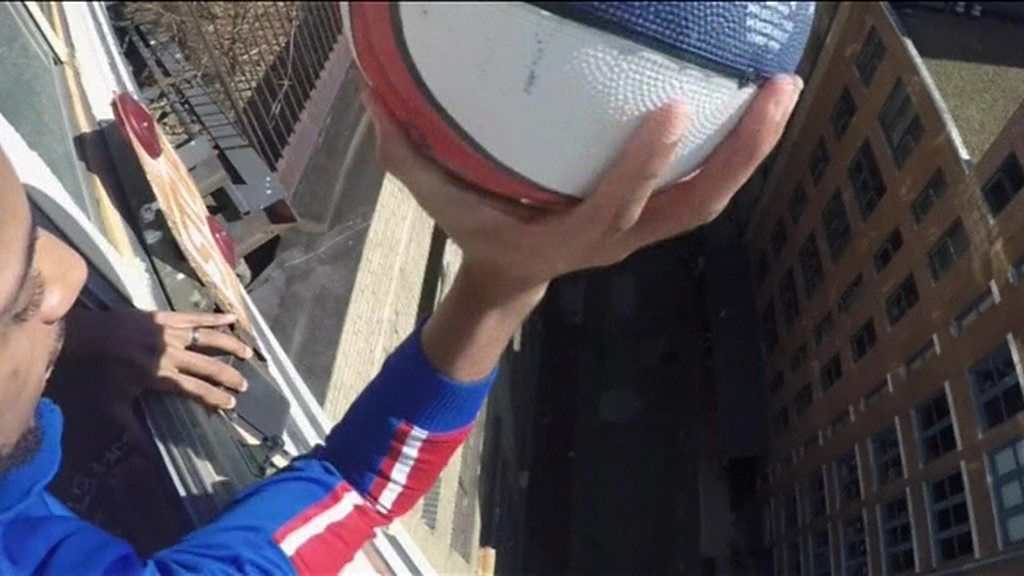 Basketball player shoots hoop off the top of a building! - BBC Newsround