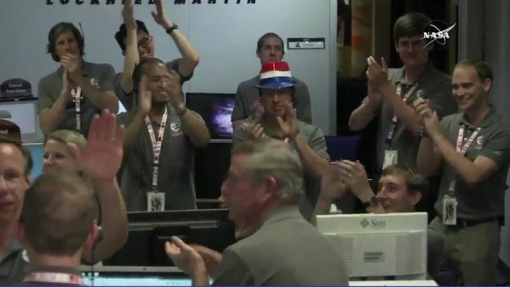 Nasa scientists celebrate Jupiter orbit - BBC Newsround
