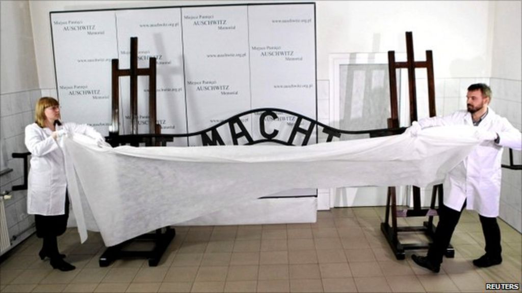 Infamous Auschwitz 'Arbeit macht frei' sign restored - BBC News