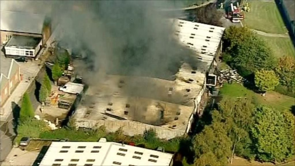 Crew tackle large fire at a Surrey industrial estate - BBC News