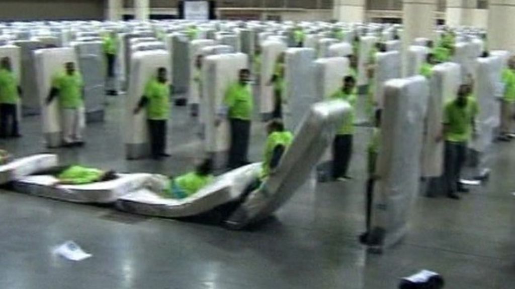 Human mattress dominoes break world record - BBC News
