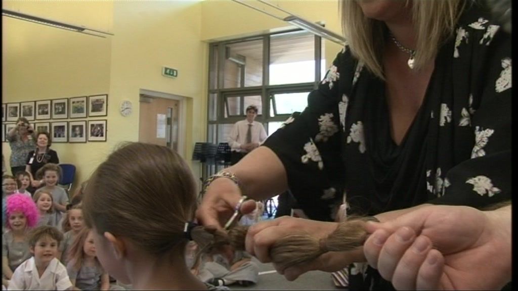 Girls get long hair cut for cancer wigs - BBC News