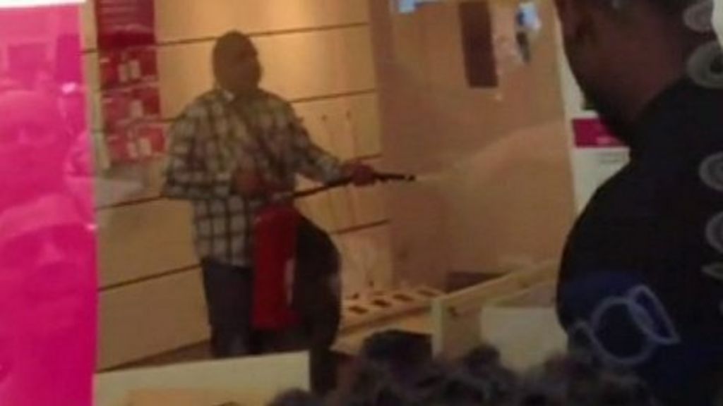 Man causes damage to Manchester T-Mobile store - BBC News