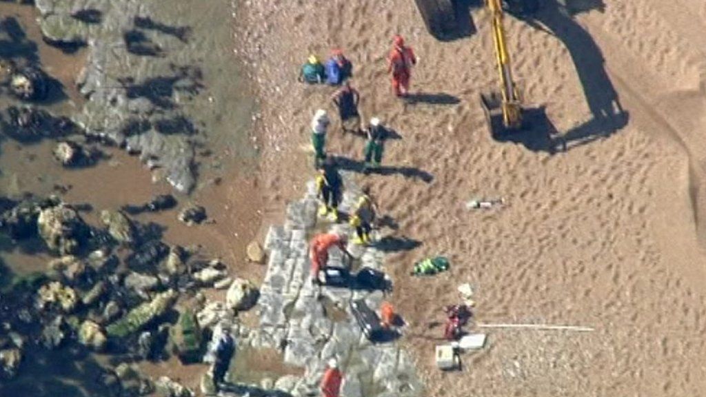 Person trapped under rocks after Dorset landslide - BBC News