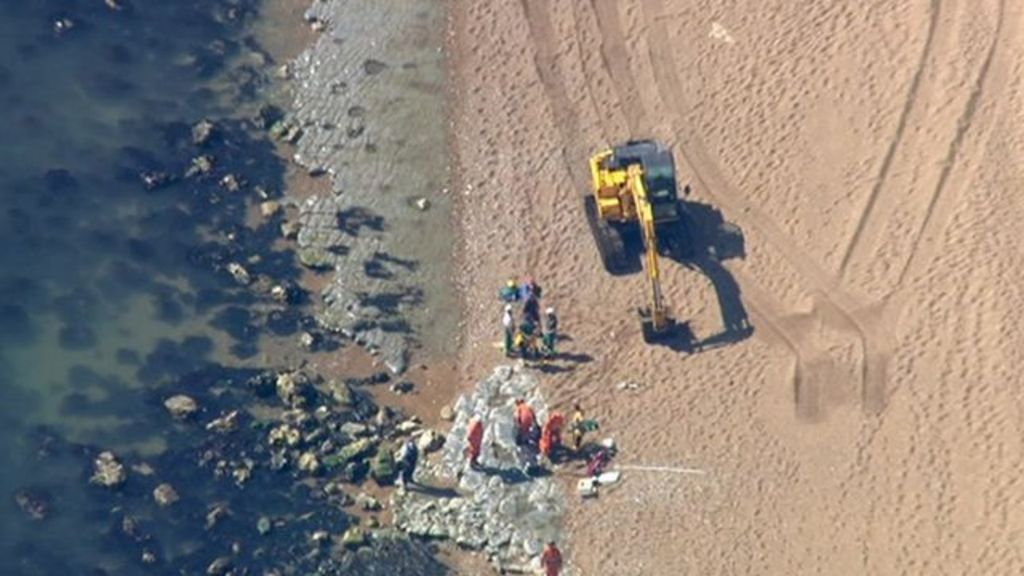 Landslip on Dorset coast: One trapped under rocks - BBC News