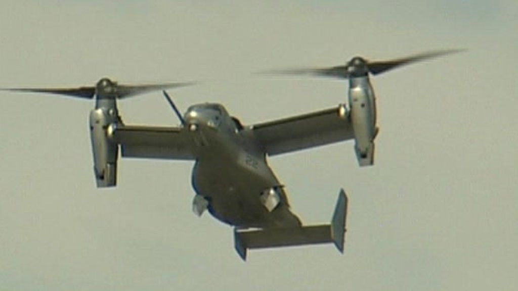 Bucket falls from US military aircraft leaving hole in building - BBC News