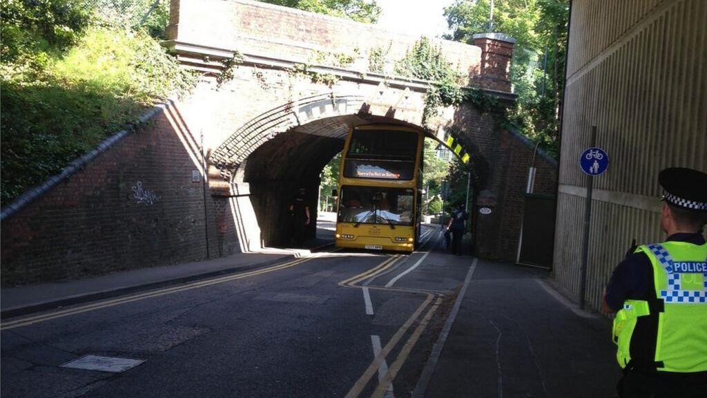 Westbourne mechanic gets bus wedged under bridge - BBC News