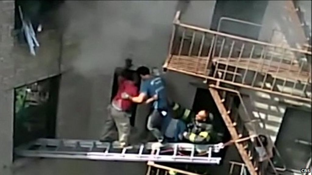 Neighbour rescued from burning building caught on camera - BBC News