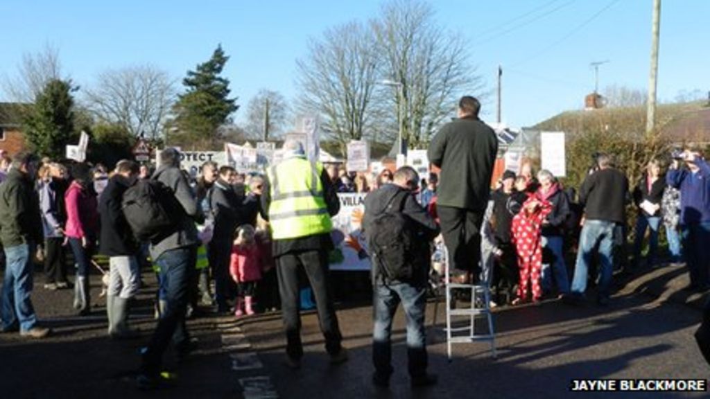 Hundreds join Feniton protest against homes - BBC News