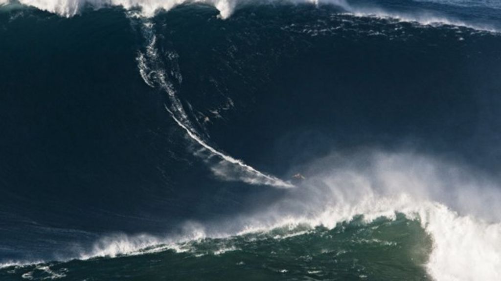 Garrett McNamara surfs record breaking wave - BBC Newsround