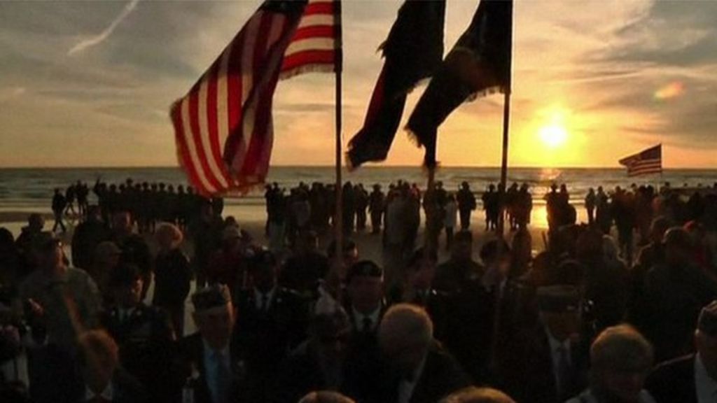 D-Day anniversary: Flags raised at sunrise service - BBC News