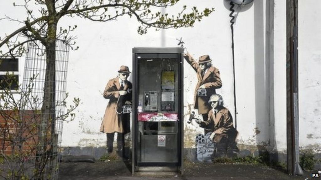 Banksy 'Spy Booth' mural in Cheltenham gets protection - BBC News