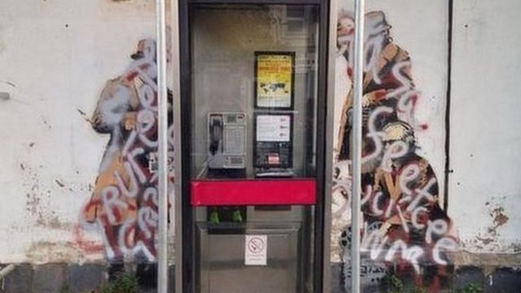 Banksy 'Spy Booth' work defaced in Cheltenham - BBC News