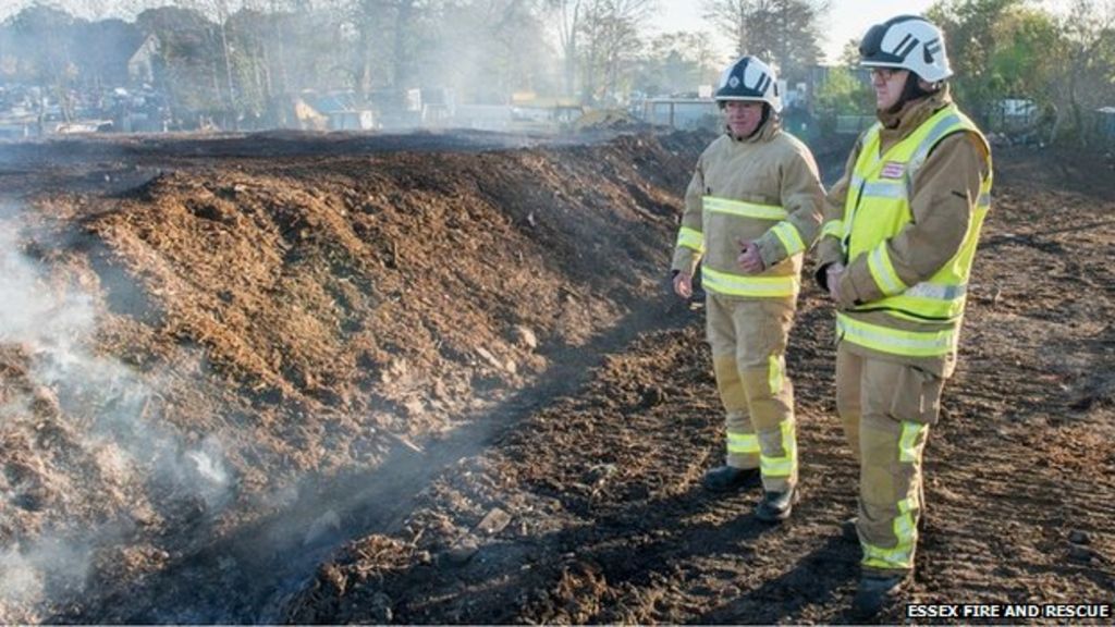 Mountnessing smouldering woodpile gets fire break trench - BBC News