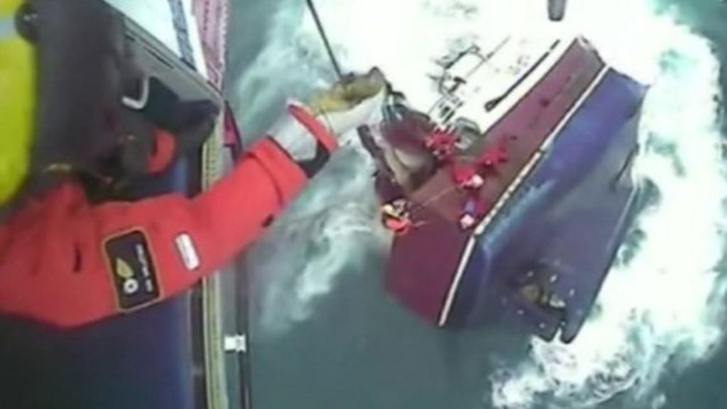 Moment coastguard rescues crew of sinking fishing boat - BBC News