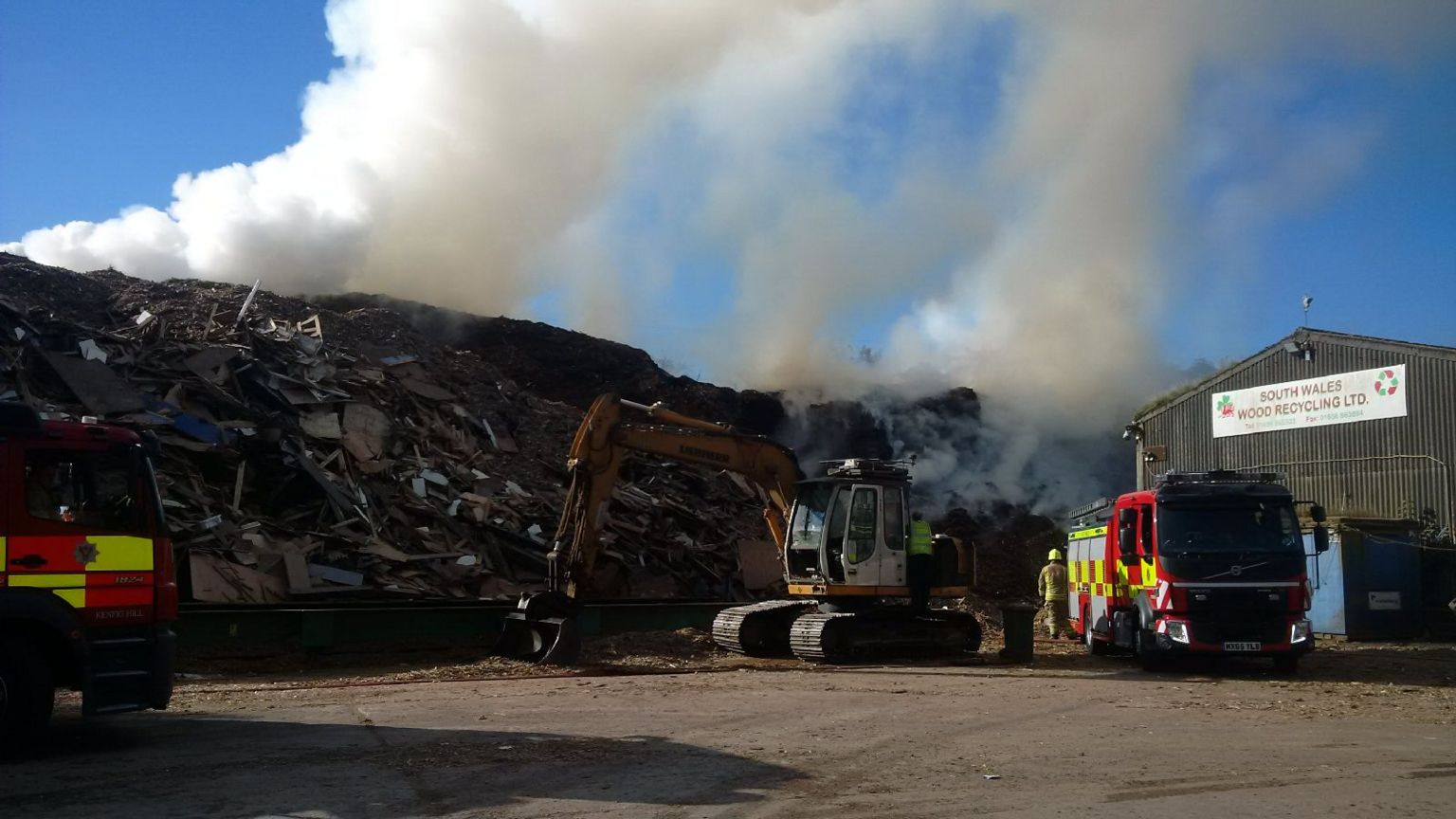Coity woodchip fire at waste plant in Bridgend ongoing - BBC News