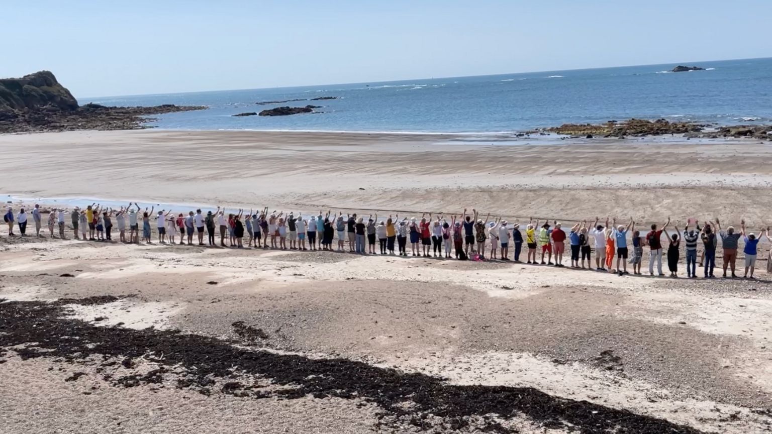 Islanders stage beach demonstration to protect Jersey coastline - BBC News