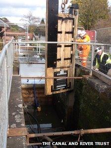 Welshpool canal: Two oak lock gates lowered into place - BBC News
