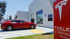 Tesla delivers 'historic' $311m profit - BBC News