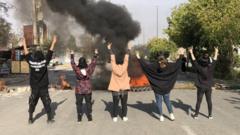 Iran protests: University students stage sit-down strikes - BBC News