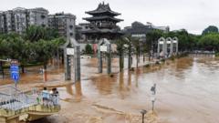 China rains: Thousands stranded after record downpour - BBC News