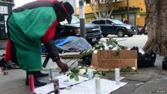 Los Angeles police chief says homeless man grabbed for gun - BBC News